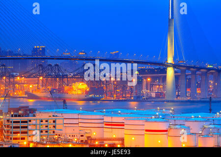 gas tank and highway bridge in sunset moment Stock Photo - Alamy