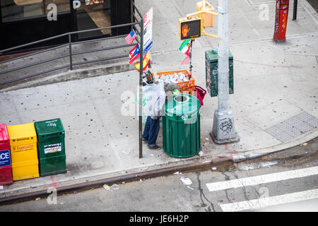 Homeless man in NYC collecting cans to take to recycle and get money in ...