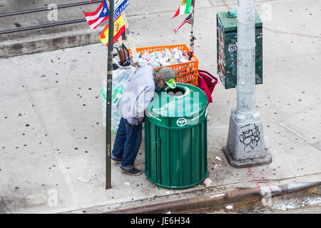 Homeless man in NYC collecting cans to take to recycle and get money in ...