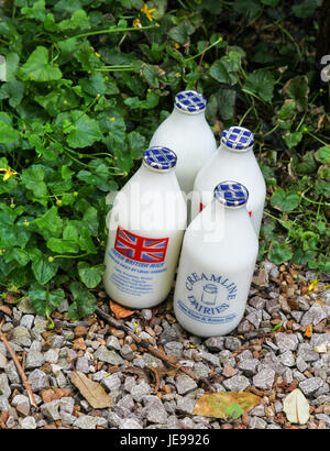 Glass bottles of delivered fresh milk on the street outside the front ...