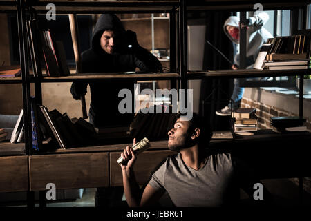 Scared man hiding from robbers and calling 911, House robbery scene ...