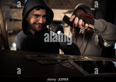 Two robbers stealing money and valuables, house robbery scene Stock ...