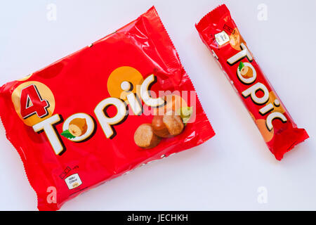 Topic chocolate bar on white background with open cut up bar by the ...