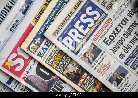 Greek newspapers on a clothesline in a newspapers shop of Piraeus ...