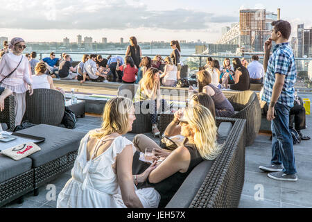 people at Ink48 Hotel rooftop bar enjoying corner perch on cushioned ...