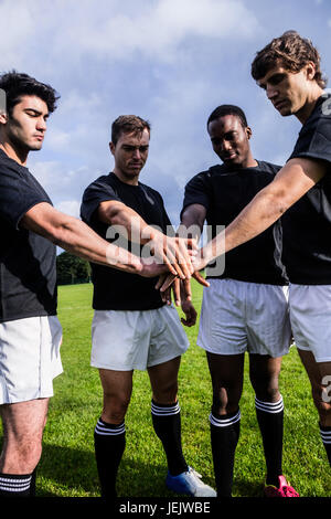 Male rugby players standing together with rugby ball in stadium Stock ...