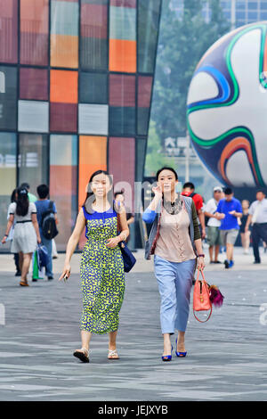 Beijing, China. Pretty Girls In Traditional Chinese Dresses Walk Along ...