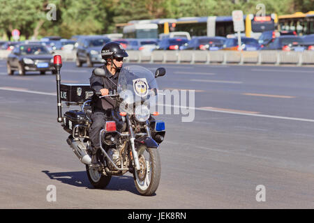 An armed motorcycle police officer of the Special Escort Group SEG ...