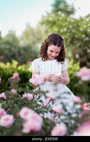 Girl picking up flowers Stock Photo - Alamy