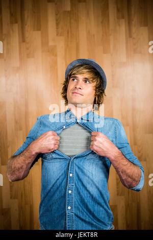 Funny blond hipster taking off his shirt Stock Photo - Alamy