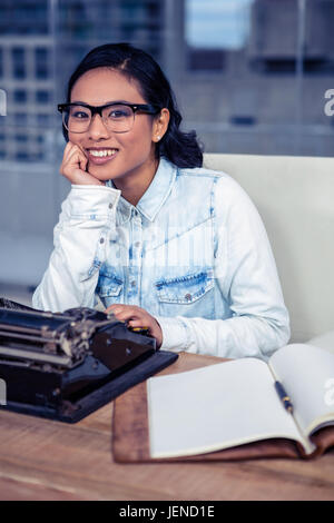 Asian woman typewriting Stock Photo - Alamy