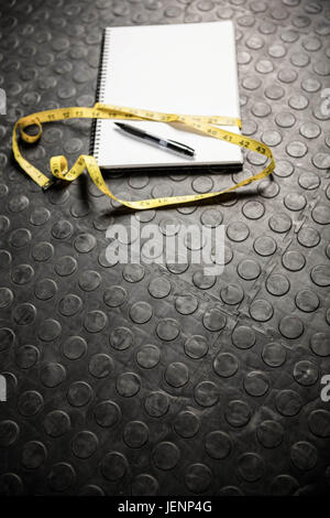 Notepad and measuring tape Stock Photo - Alamy
