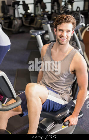 Fit man doing exercise bike Stock Photo - Alamy