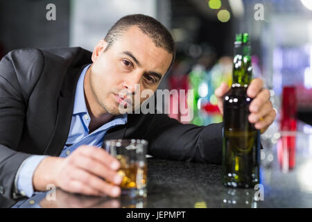 Drunk man slumped on bar asleep Stock Photo - Alamy