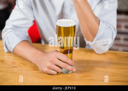 Masculine arms holding a beer Stock Photo - Alamy