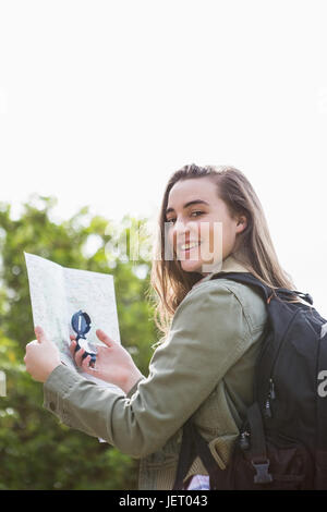Woman using map and compass Stock Photo - Alamy