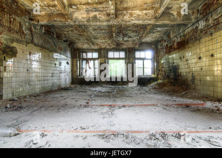 A derelict abandoned uninhabited building interior room with peeling ...