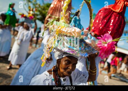A woman carries a statue of the African sea goddess Yemanja at Ramirez ...