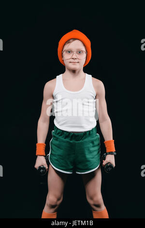 Child boy working out with dumbbells on park background. Kids sport ...