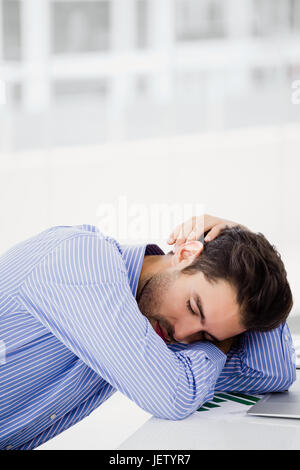 Businessman putting his head down on desk Stock Photo - Alamy