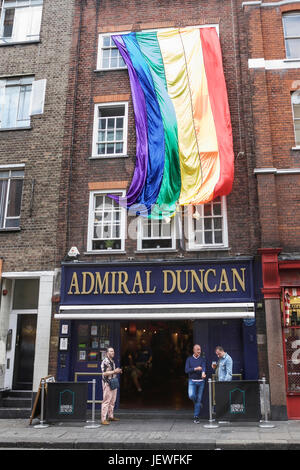 LGBT flag in Soho,London. People walking in Soho London,Brewer street ...