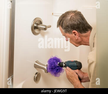 Senior man cleaning a shower with power drill Stock Photo - Alamy