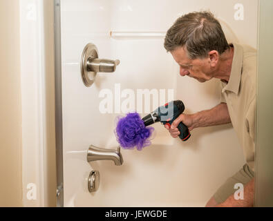 Senior man cleaning a shower with power drill Stock Photo - Alamy
