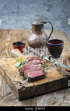 Barbecue aged Wagyu Tagliata di Manzo with lambs lettuce as close-up on ...