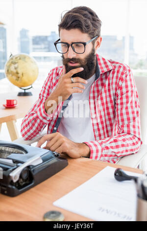 Hipster man using a typewriter Stock Photo - Alamy