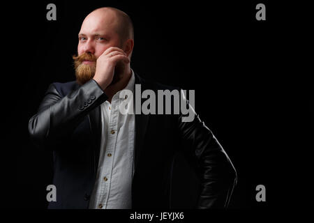 Man curls his ginger mustache Stock Photo - Alamy
