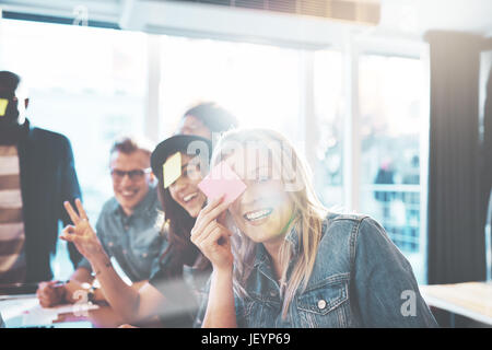 Team of business men and women covering one eye with hand with ...