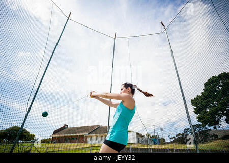 Female athlete performing a hammer throw Stock Photo - Alamy