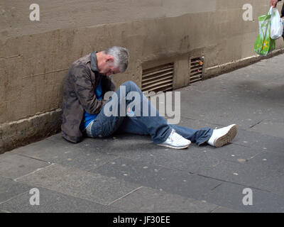 Unconscious drunk man outdoors. Person lying on the pavement Stock ...