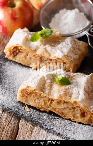 apple pastry strudel roll with cinnamon on grey marble table Stock ...