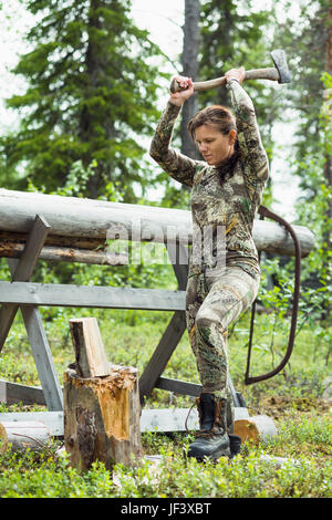 Woman chopping wood Stock Photo - Alamy