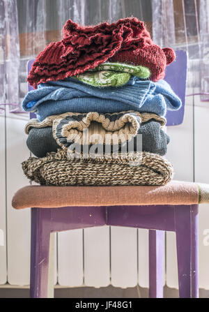 Winter clothes stacked Stock Photo - Alamy