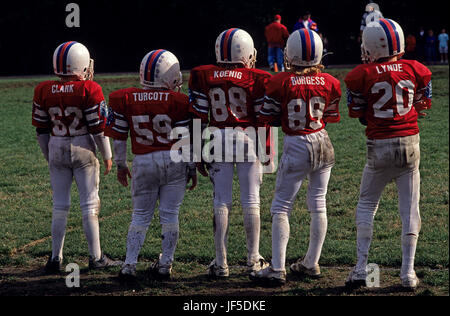 Football team along sidelines during game with backs to camera waiting ...
