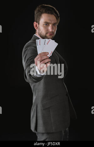 Show me the money. Studio shot of a businessman holding a fan of money ...