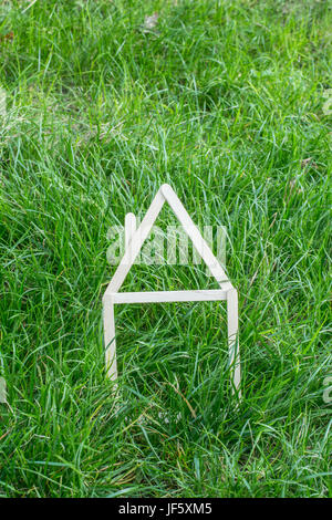 Model house made on green grass Stock Photo - Alamy