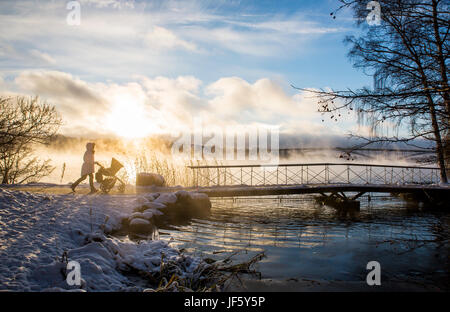 Woman with pram crossing footbridge Stock Photo - Alamy