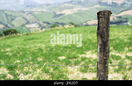 Italian agriculture village. Fence and meadow Stock Photo - Alamy