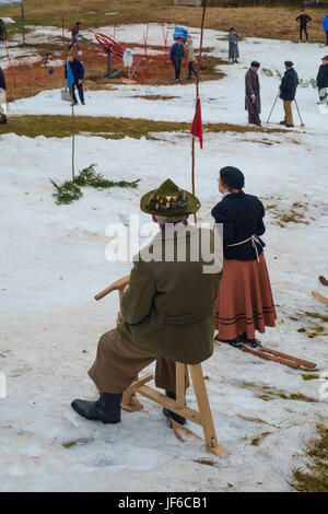 Skiers in traditional retro style costumes, with old wooden ski gear at ...