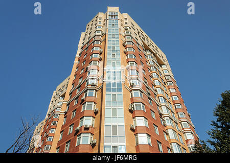 Corner of a modern residential high-rise building with glass railings ...