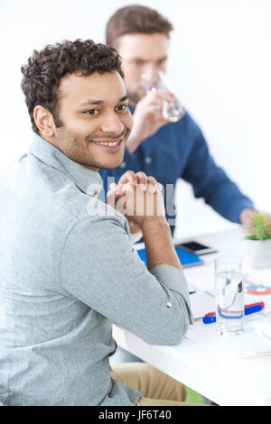 Colleagues discuss work. African young woman, caucasian man and red ...