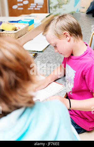 teacher checking students work on computer screen Stock Photo - Alamy