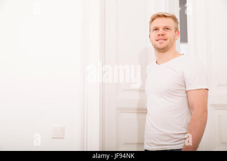 Young man coming home Stock Photo - Alamy