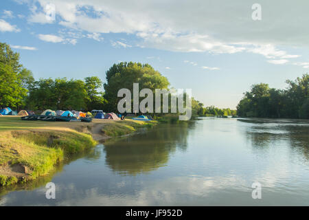 camping area with tents near river Stock Photo - Alamy