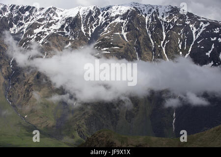 Clouds Flying Between Mountains Stock Photo - Alamy