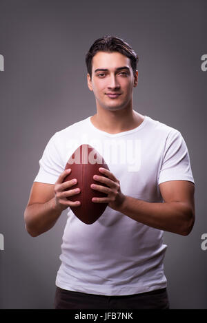 Ripped muscular man with american football Stock Photo - Alamy