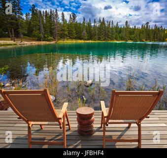 two comfortable lounge chairs in hall with white walls Stock Photo - Alamy